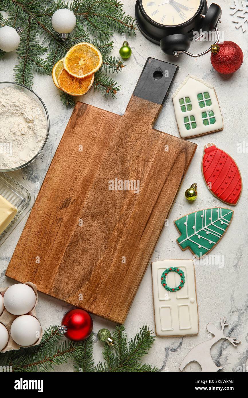Composition with wooden cutting board, Christmas cookies, ingredients ...