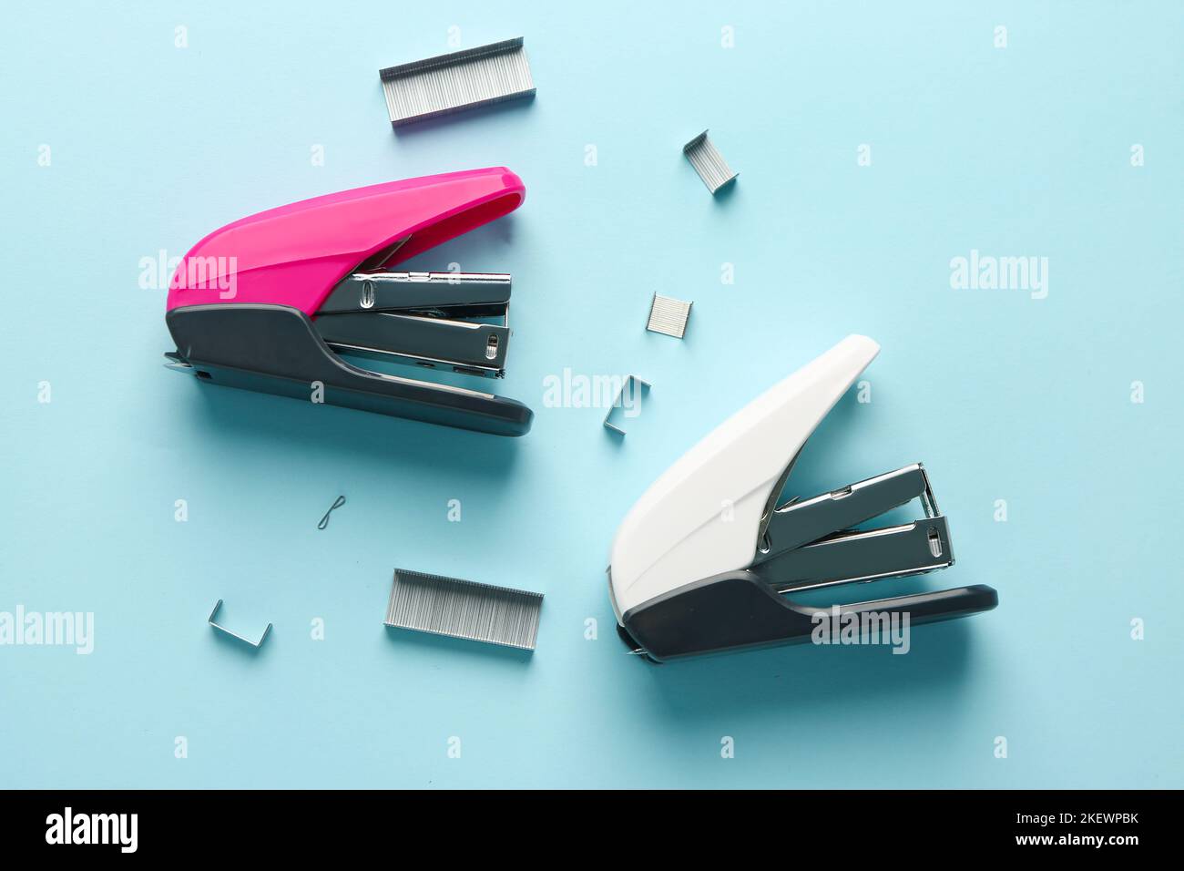 Office staplers and staples on color background Stock Photo - Alamy