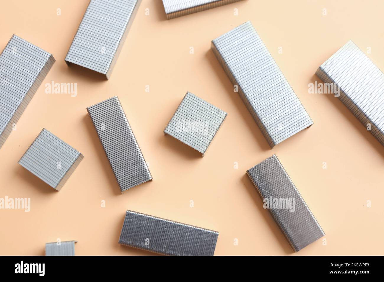 Metal staples on color background Stock Photo - Alamy