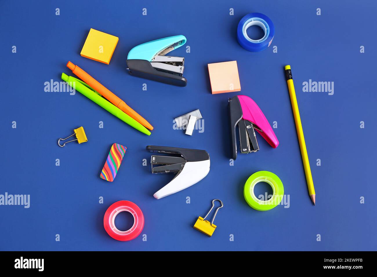 Set of stationery with staplers on blue background Stock Photo - Alamy