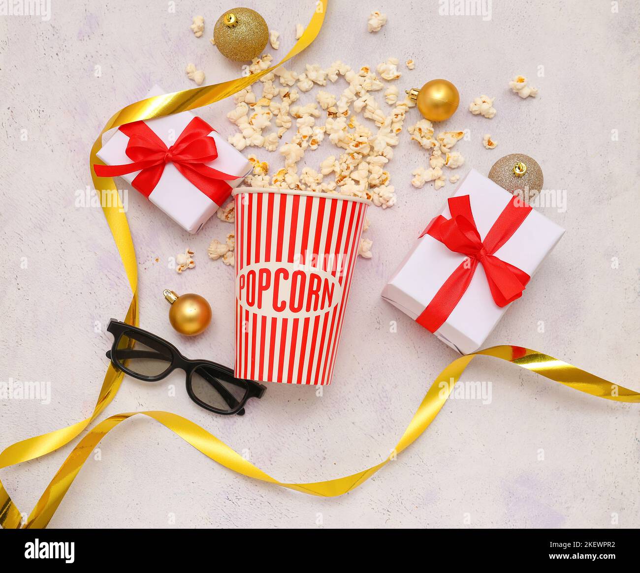 Bucket of popcorn, 3D glasses, Christmas balls, ribbon and gifts on ...