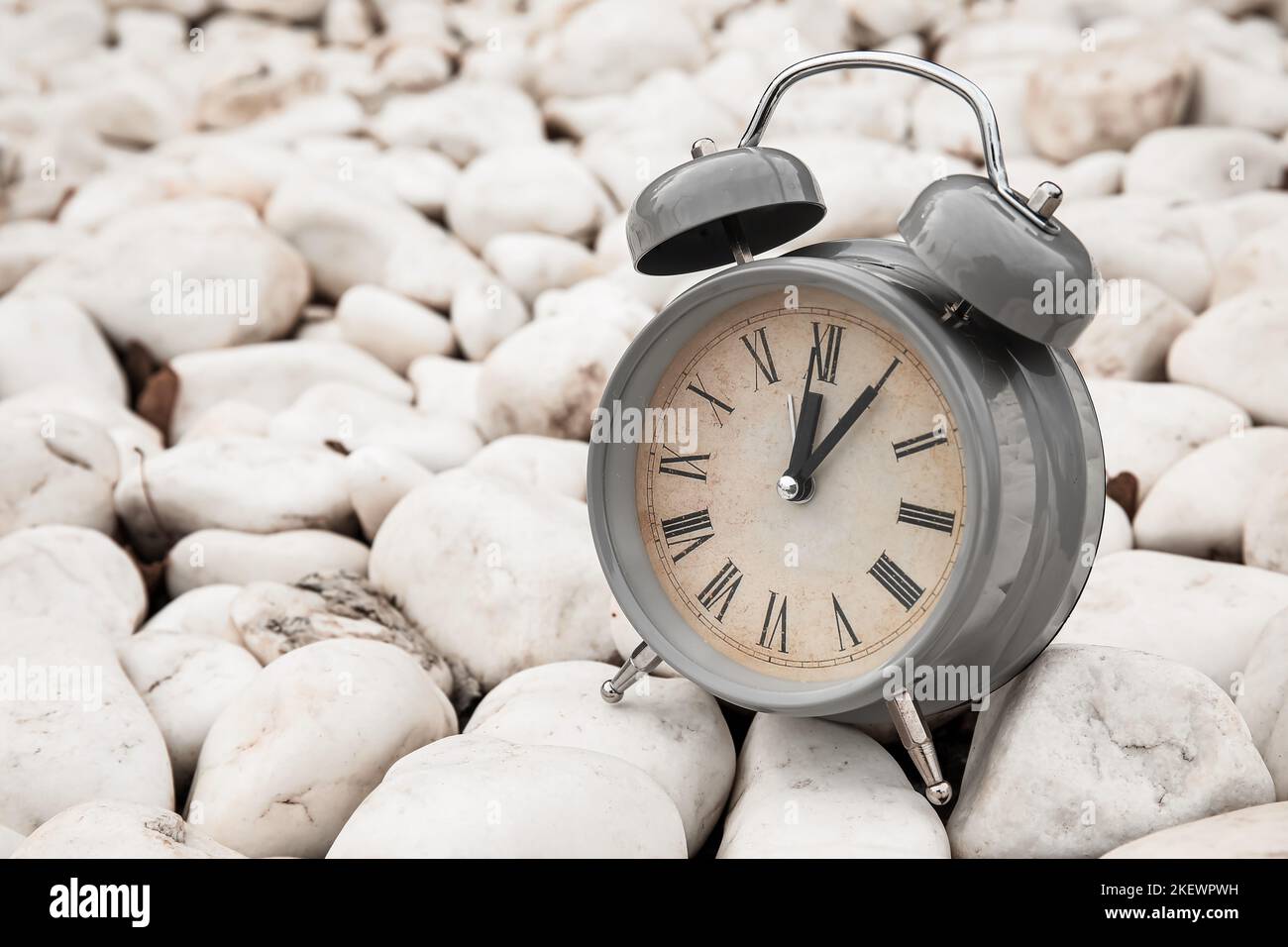 Vintage alarm clock on white stones, closeup Stock Photo - Alamy