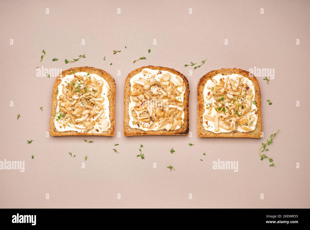 Tasty toasts with cream cheese, mushrooms and thyme on color background ...
