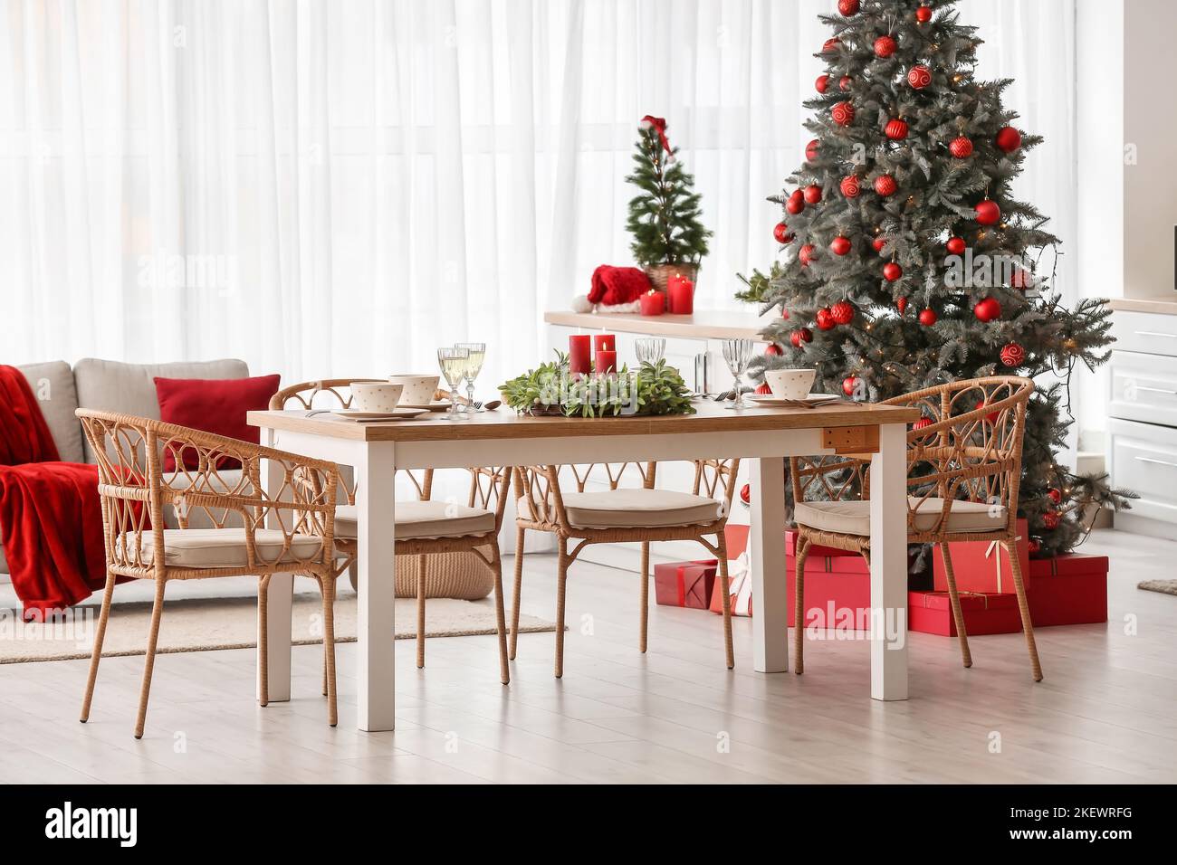 Interior of kitchen with Christmas trees and dining table Stock Photo ...