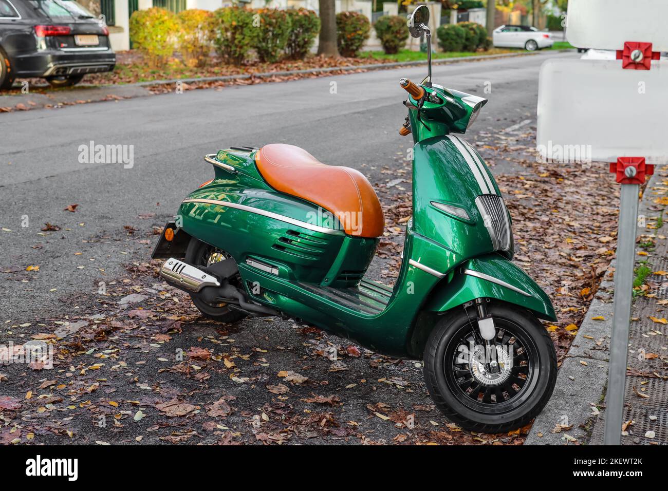 Green moped parked on city street Stock Photo - Alamy