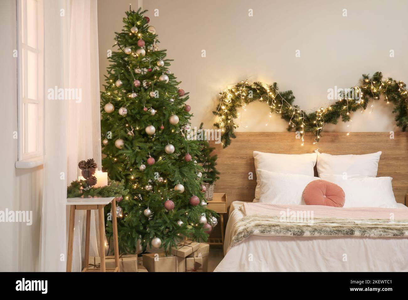 Interior of bedroom with glowing Christmas trees and fir branches Stock ...