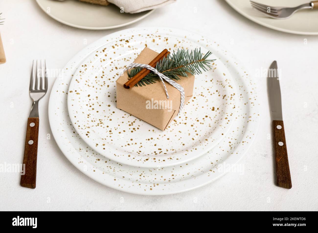 Christmas table setting with fir branch and cinnamon on white ...