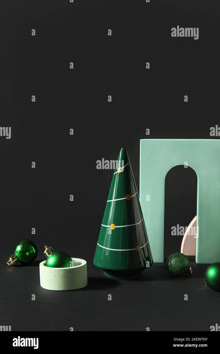Decorative Christmas tree with podiums and balls on black background ...