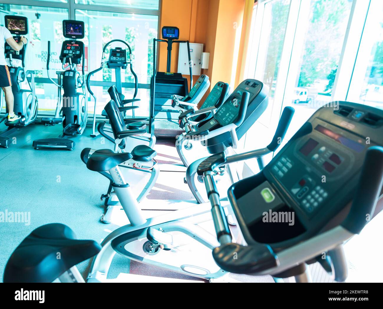 Interior of modern gym fitness room with large windows and treadmills ...