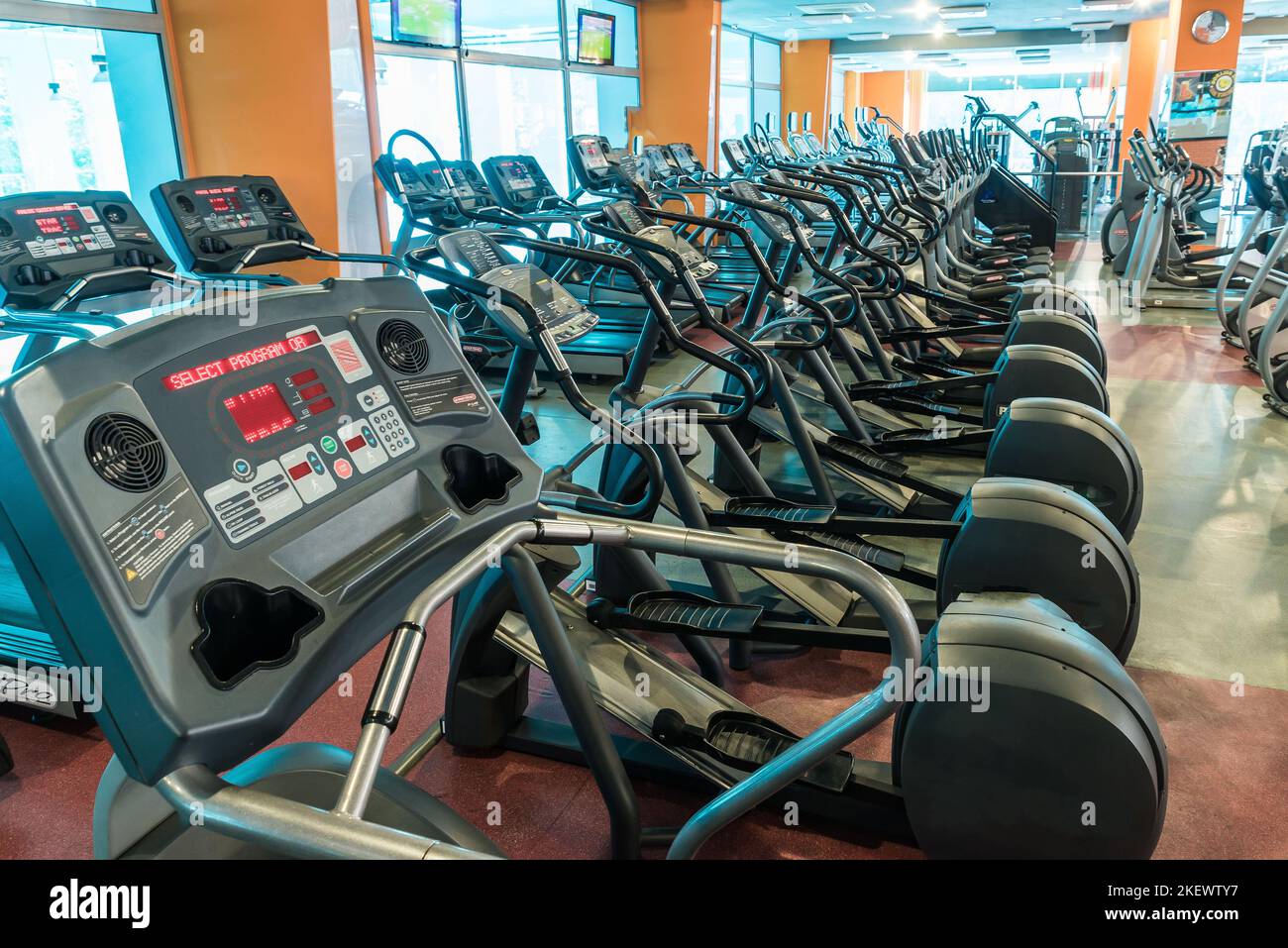 Interior of modern gym fitness room with large windows and treadmills ...