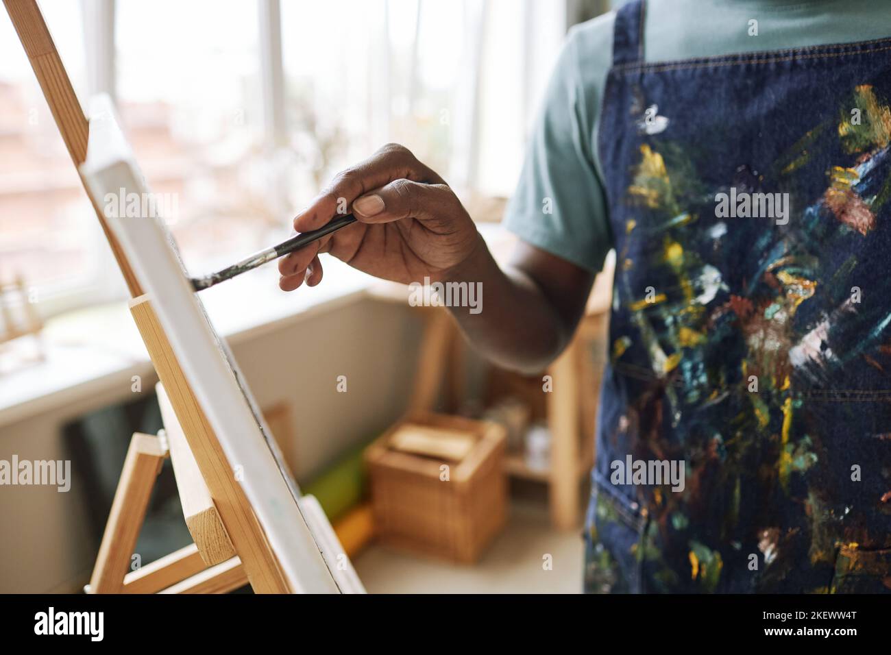 Hand of young contemporary painter with paintbrush creating new ...