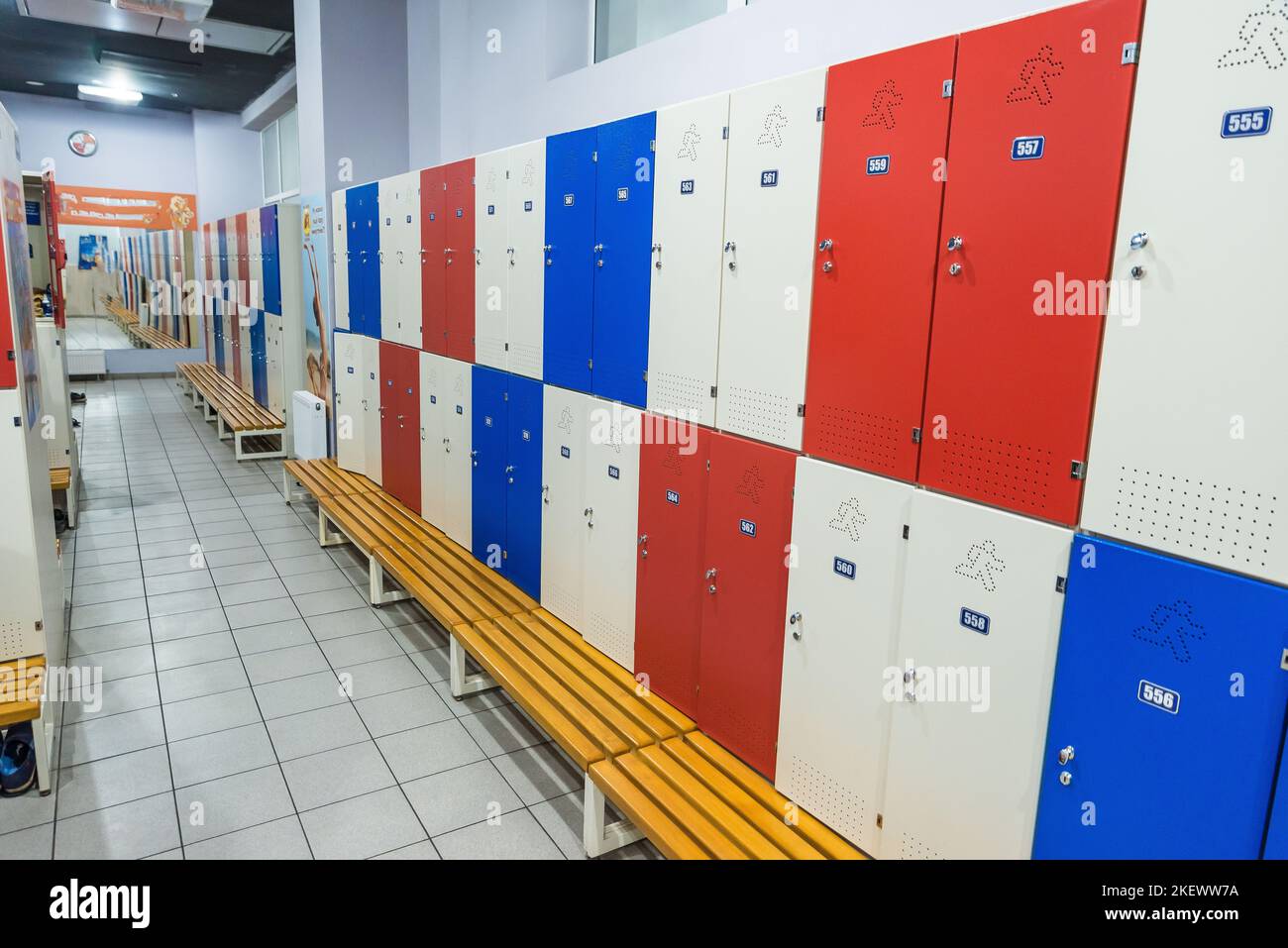 Red lockers in generic locker room with wooden bench red blue white ...