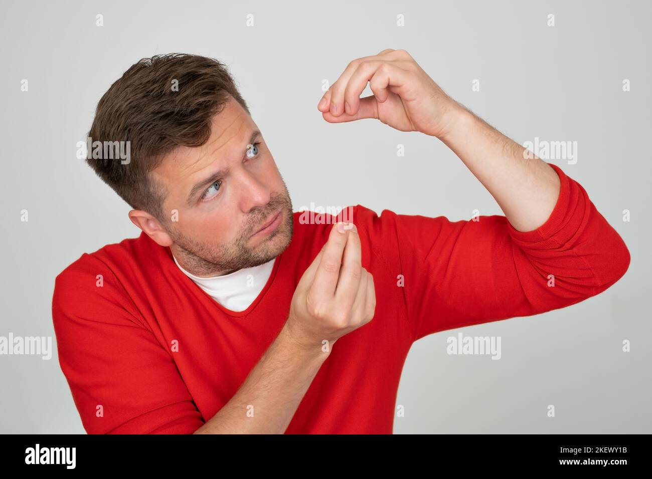 Mature man show tiny small size measures with fingers Stock Photo - Alamy
