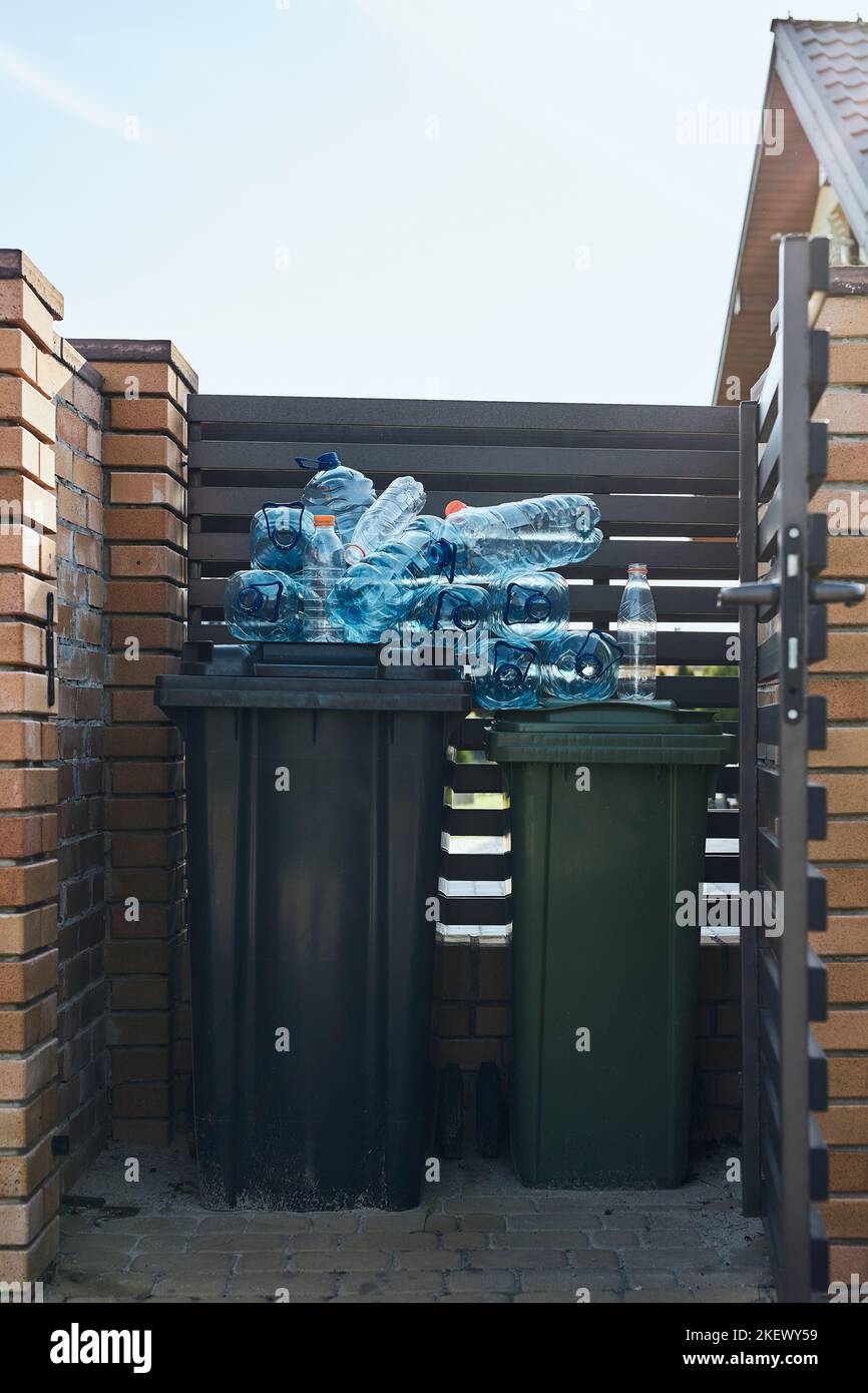 Disposal containers with empty used plastic water bottles on the top ...