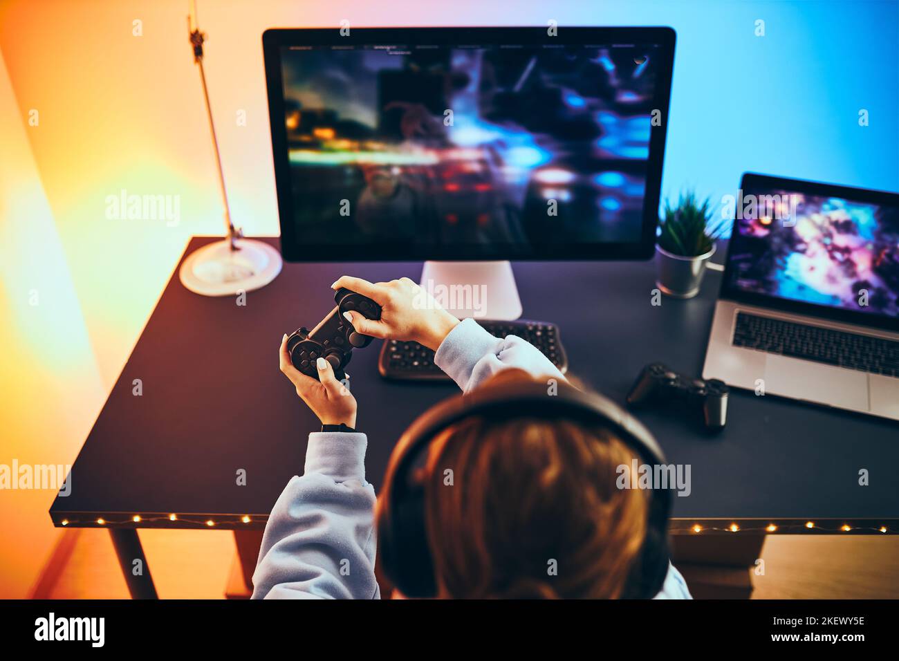 Teenager girl playing video game at home. Gamer holding gamepads ...