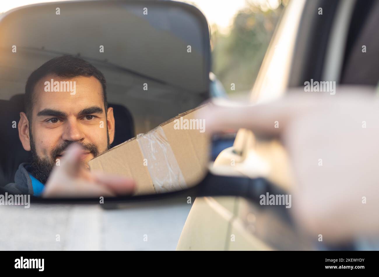Delivery man working inside a van holding a parcel ready to deliver ...