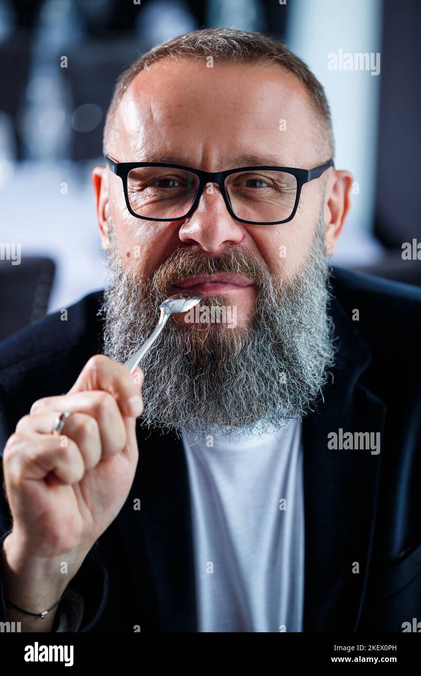Portrait of a gray-haired adult successful man with a beard businessman ...