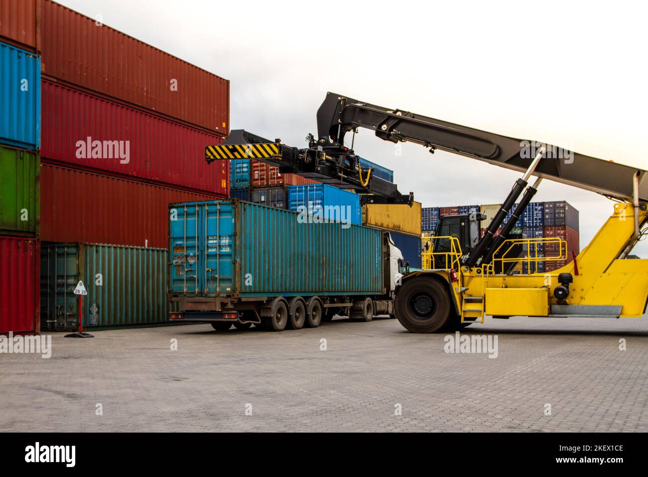 Truck while loading in logistic shipping yard with cargo container ...