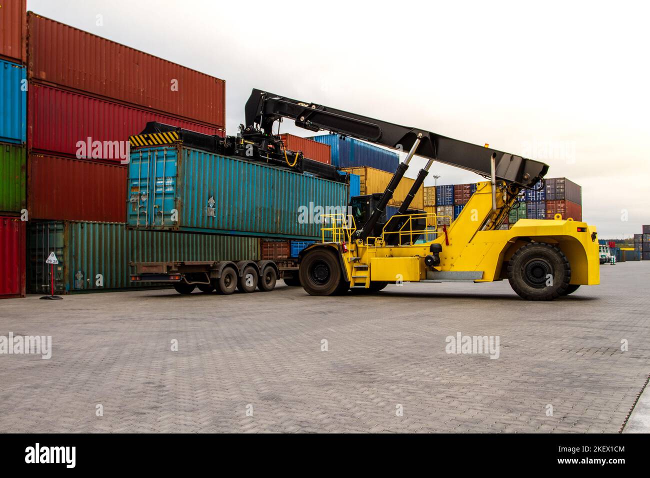 Truck while loading in logistic shipping yard with cargo container ...