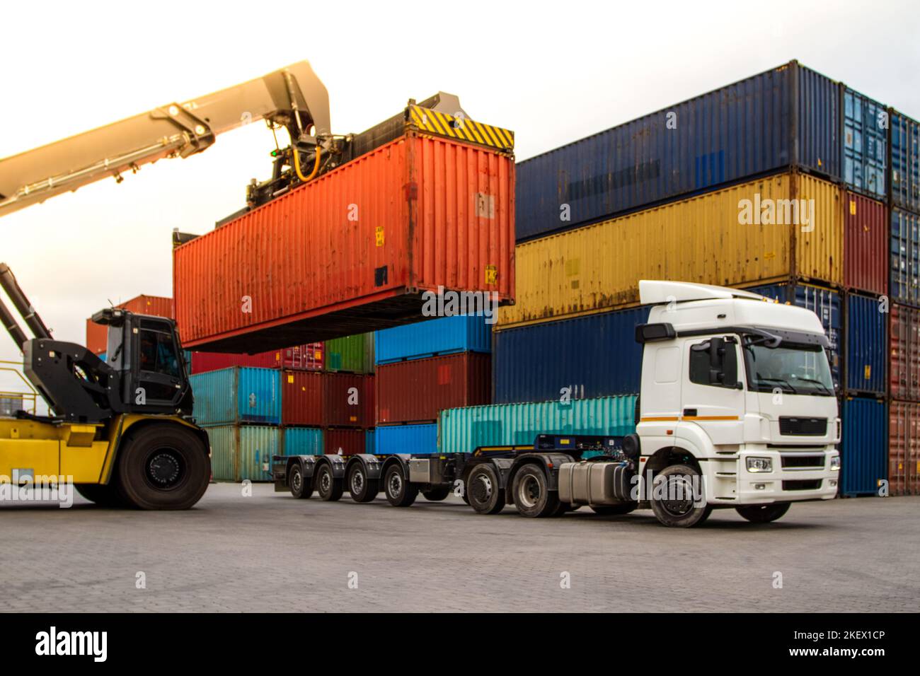 Truck while loading in logistic shipping yard with cargo container ...