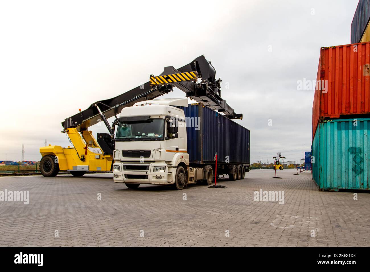Truck while loading in logistic shipping yard with cargo container ...