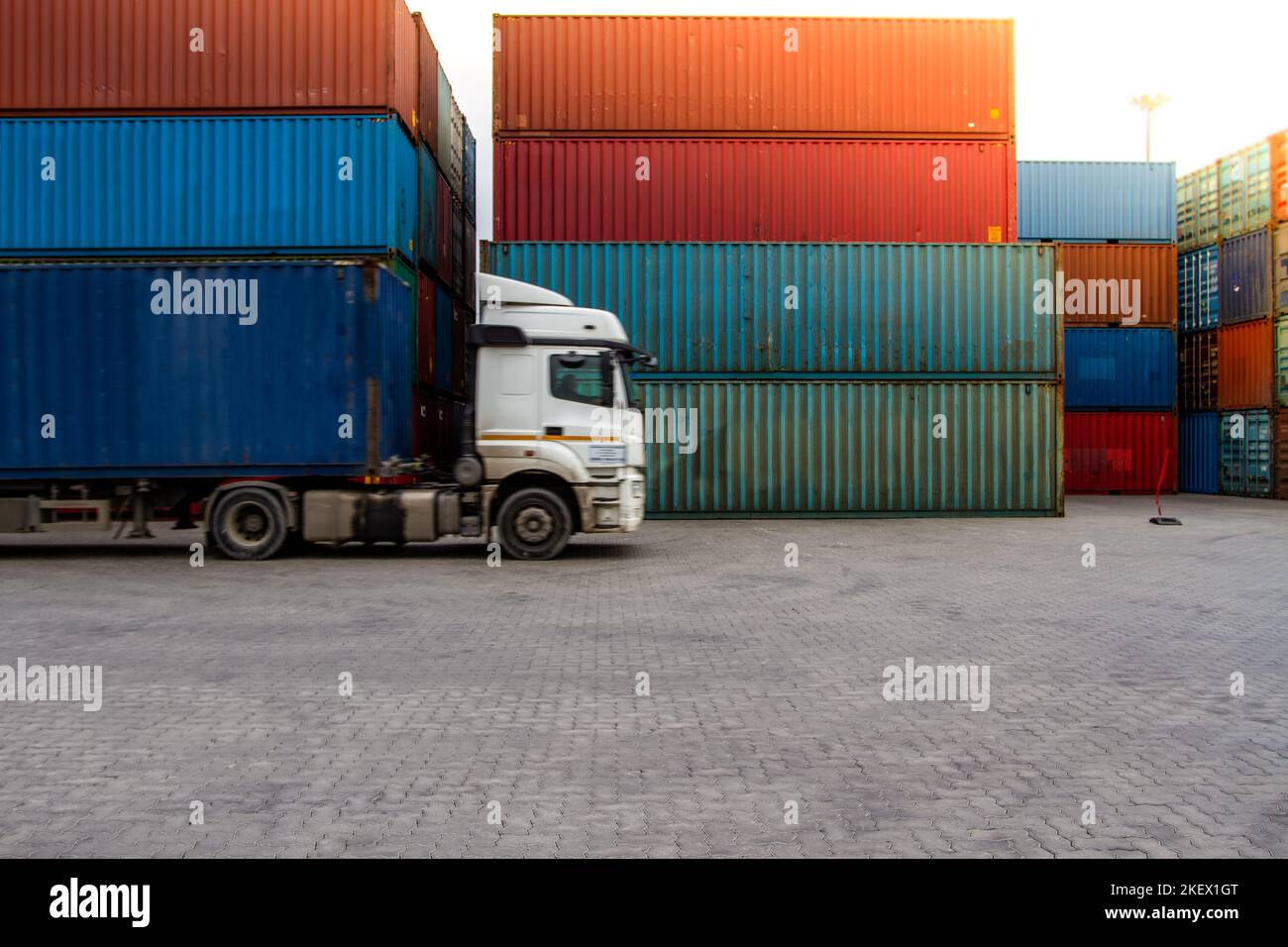 Truck while loading in logistic shipping yard with cargo container ...