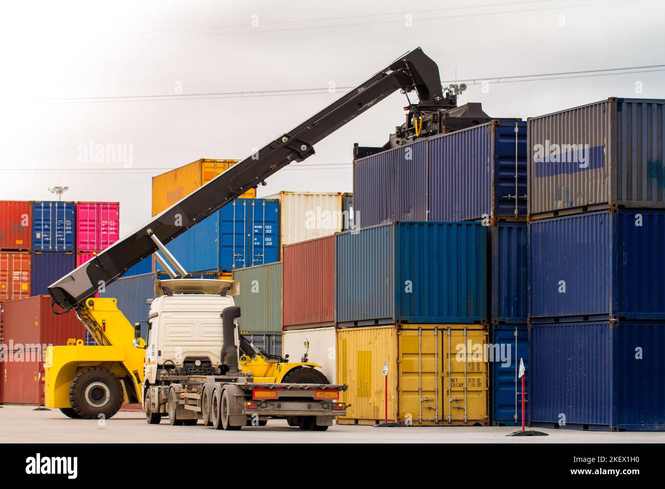 Truck while loading in logistic shipping yard with cargo container ...