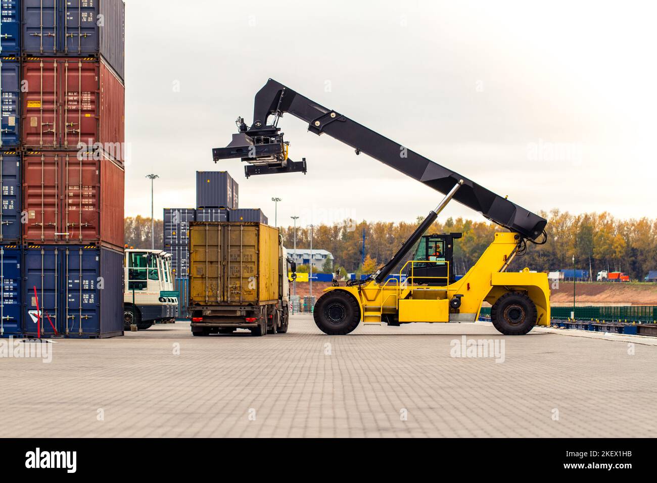 Truck while loading in logistic shipping yard with cargo container ...