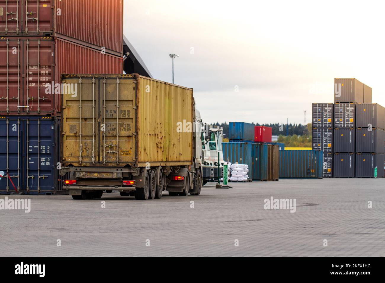 Truck while loading in logistic shipping yard with cargo container ...