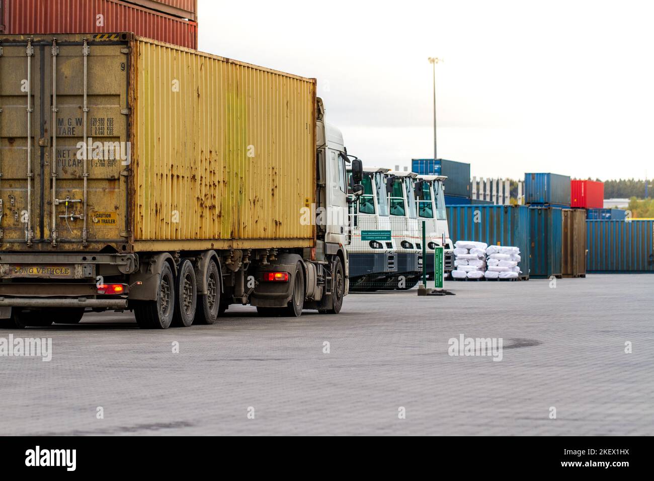 Truck while loading in logistic shipping yard with cargo container ...