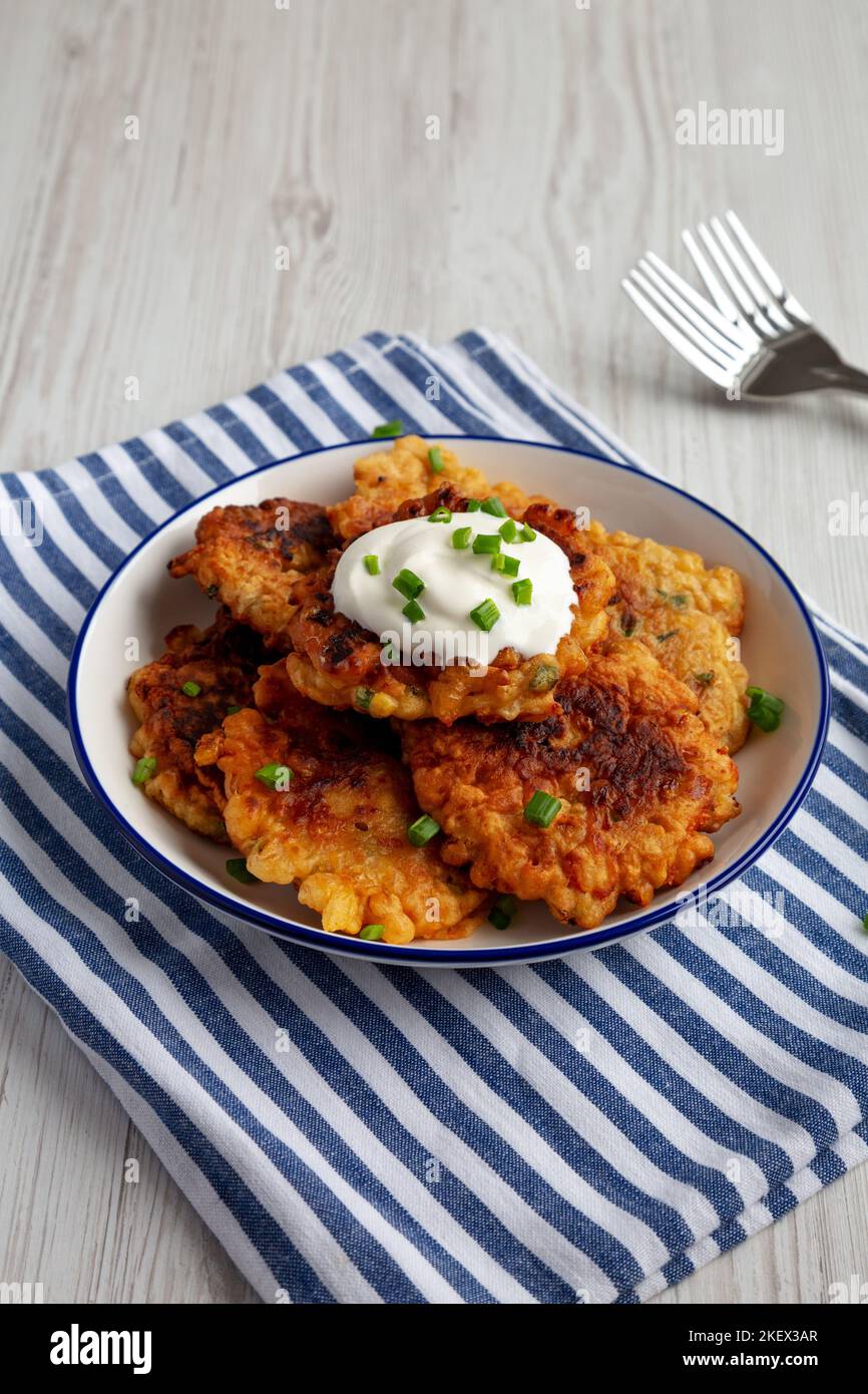 Homemade Fried Cheddar Corn Fritters on a Plate, side view Stock Photo ...