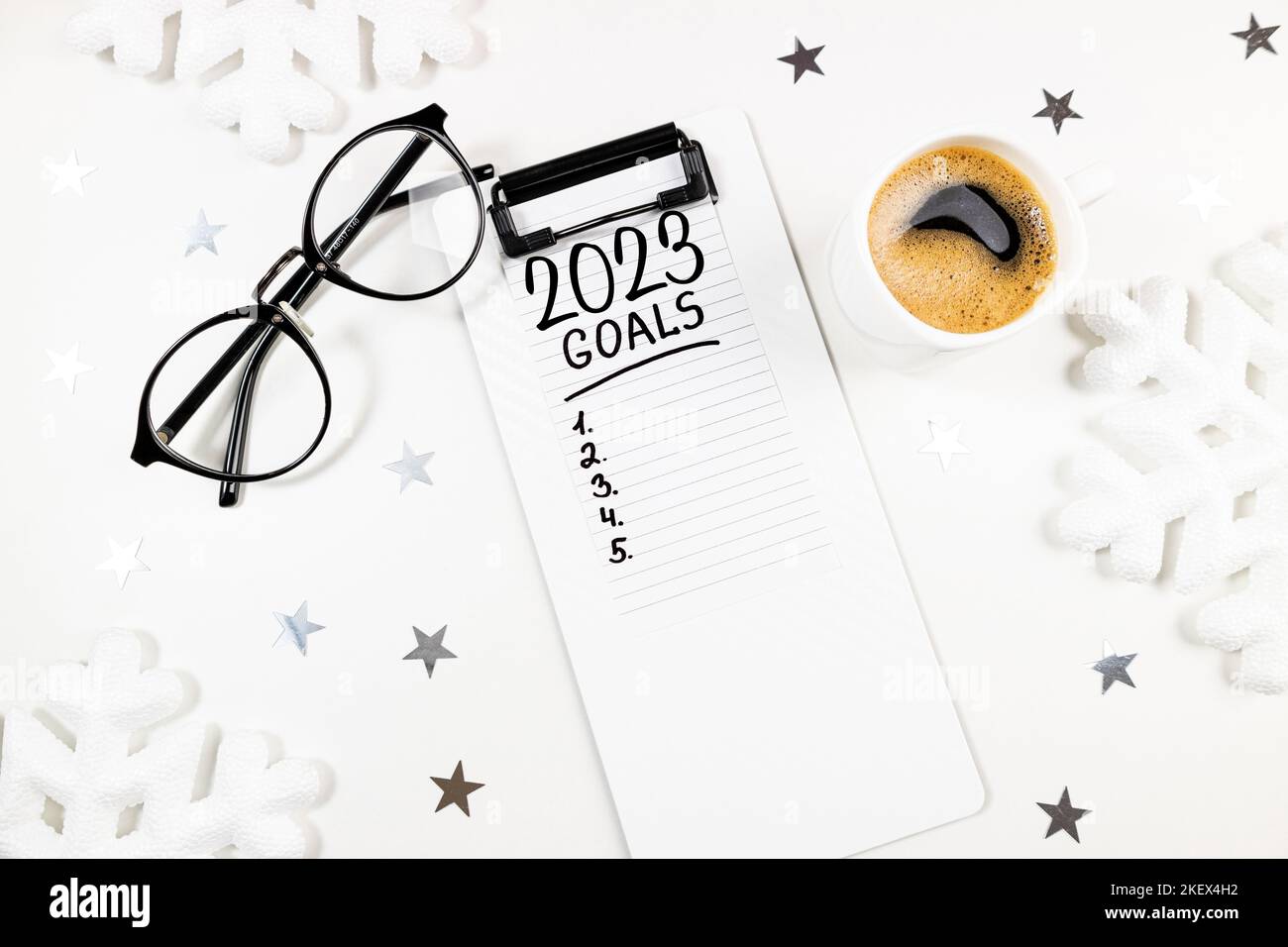 New year resolutions 2023 on white desk. 2023 resolutions list with ...