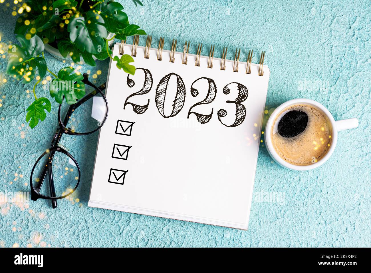 New year goals 2023 on desk. 2023 goals list with notebook, coffee cup ...