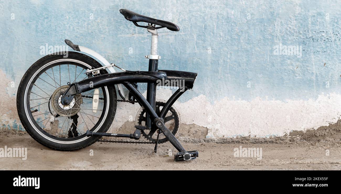 Back half of a bicycle broken into two parts against the wall Stock ...