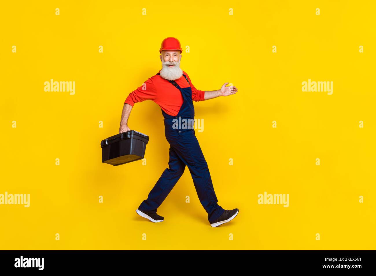 Full length photo of optimistic senior engineer with white beard red ...