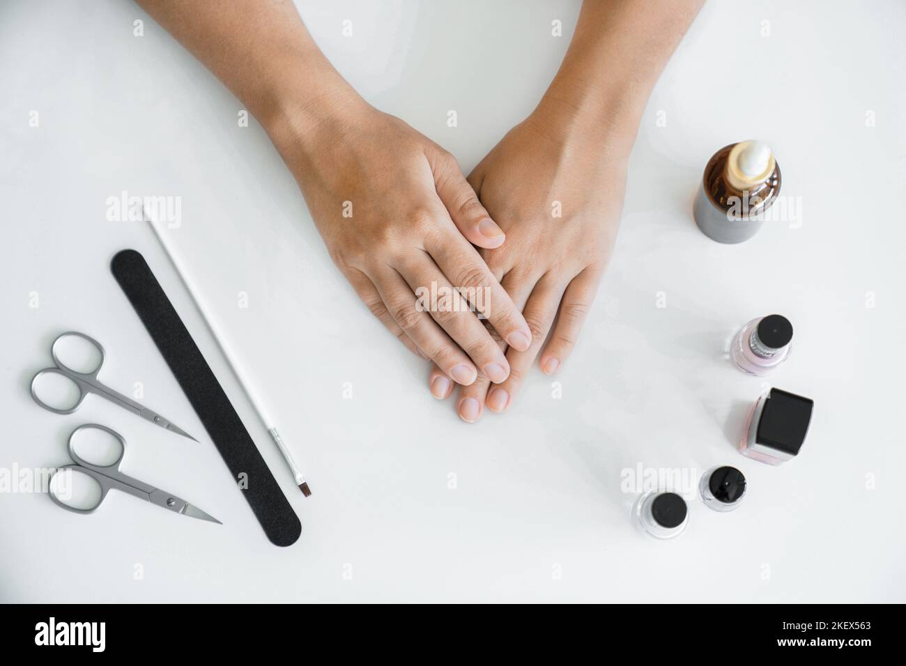 Concept of hand care. Women's hands without manicure are lying on table ...