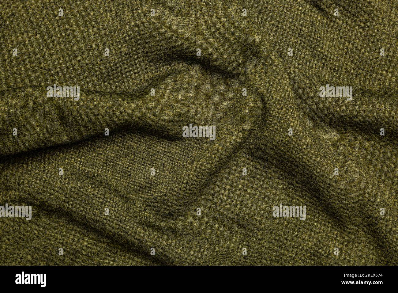 Texture of knitted fabric in green color. Light khaki background Stock ...