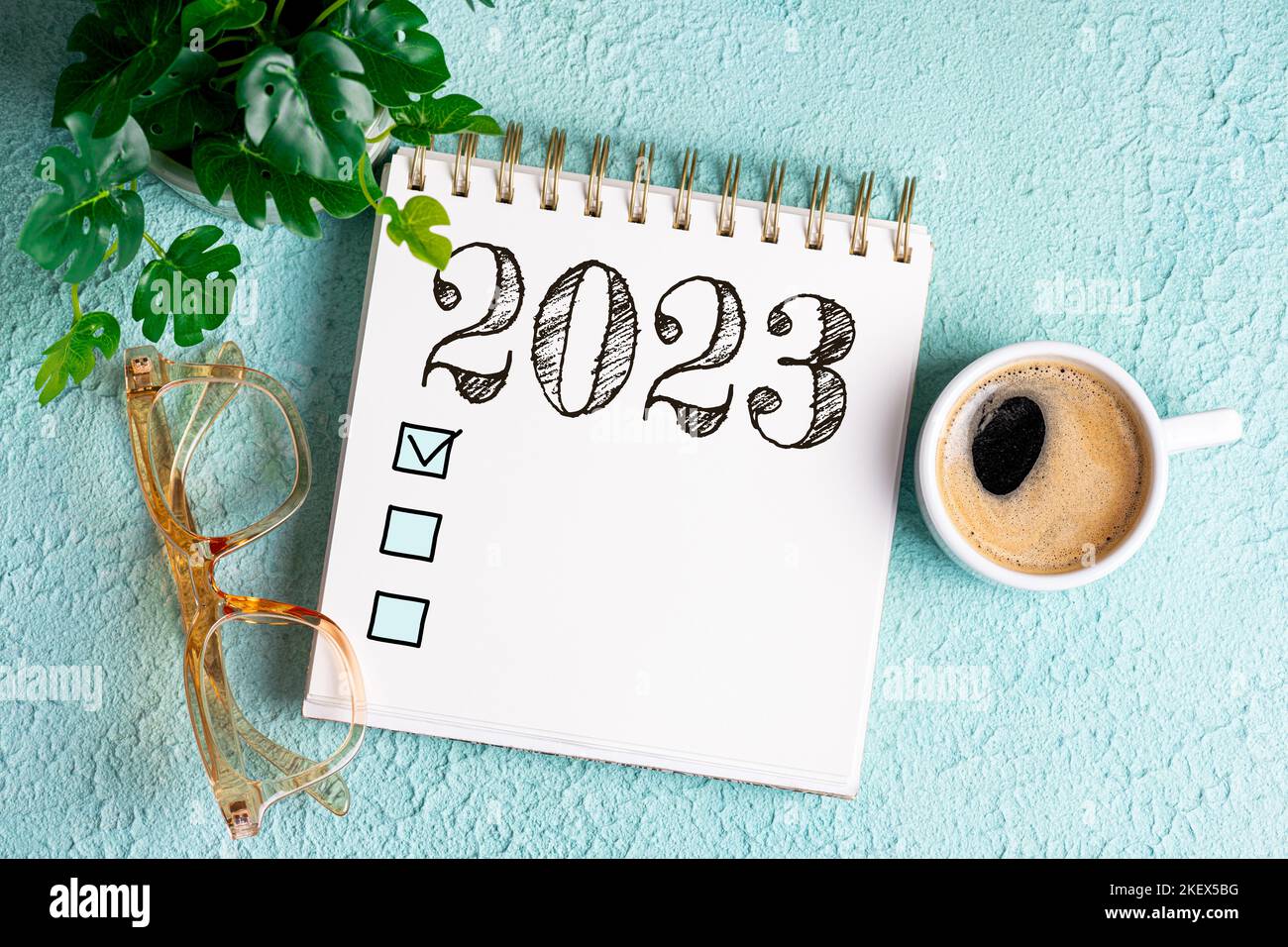 New year goals 2023 on desk. 2023 goals list with notebook, coffee cup ...