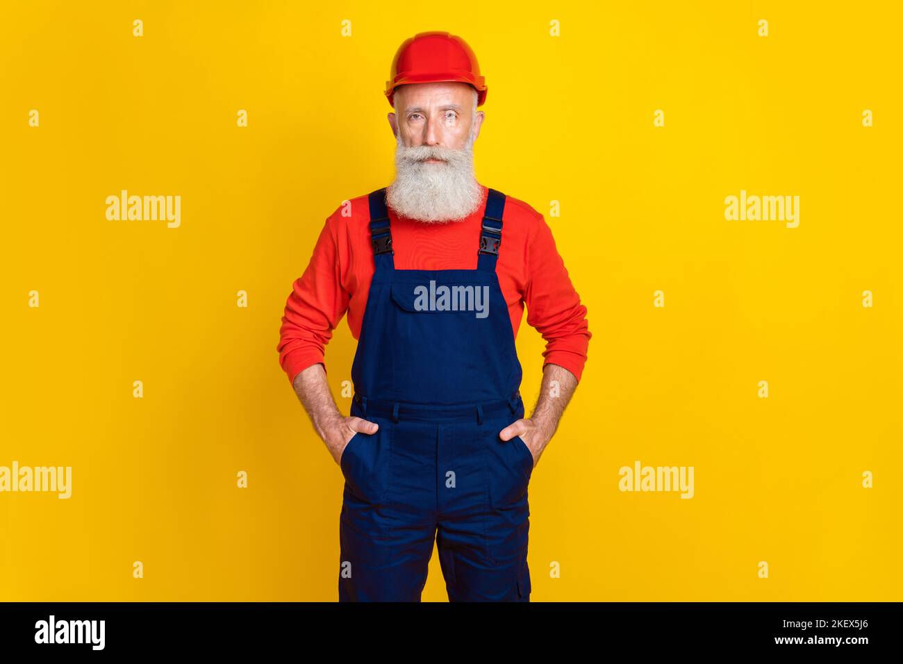 Photo of serious confident age man workwear overall red hard hat arms ...