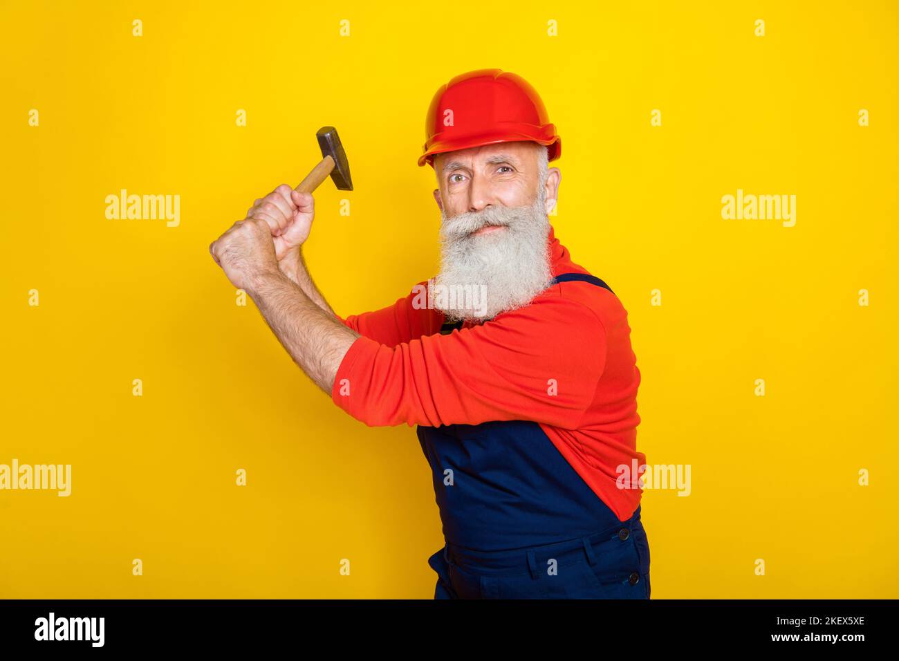 Photo of strong angry age man wear overall uniform red hard hat rising ...