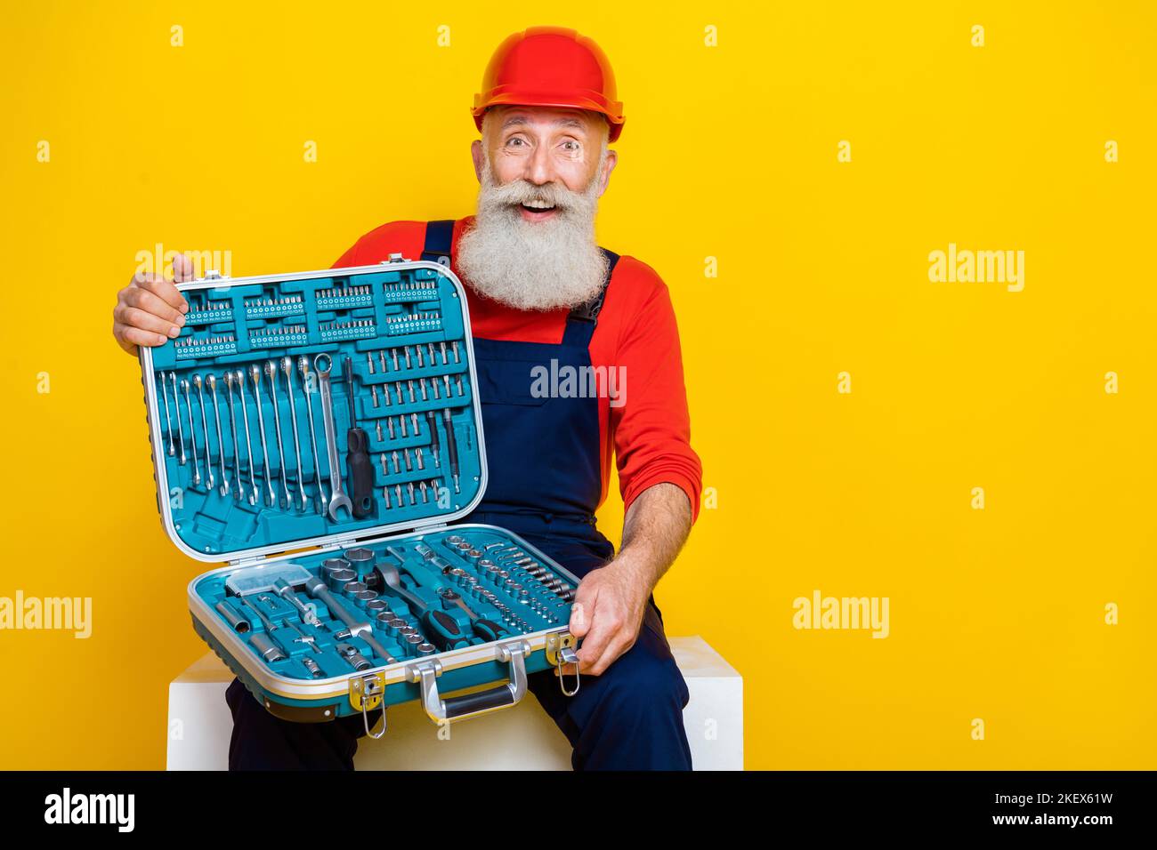 Photo of happy smiling old guy dressed uniform overall red hardhat ...