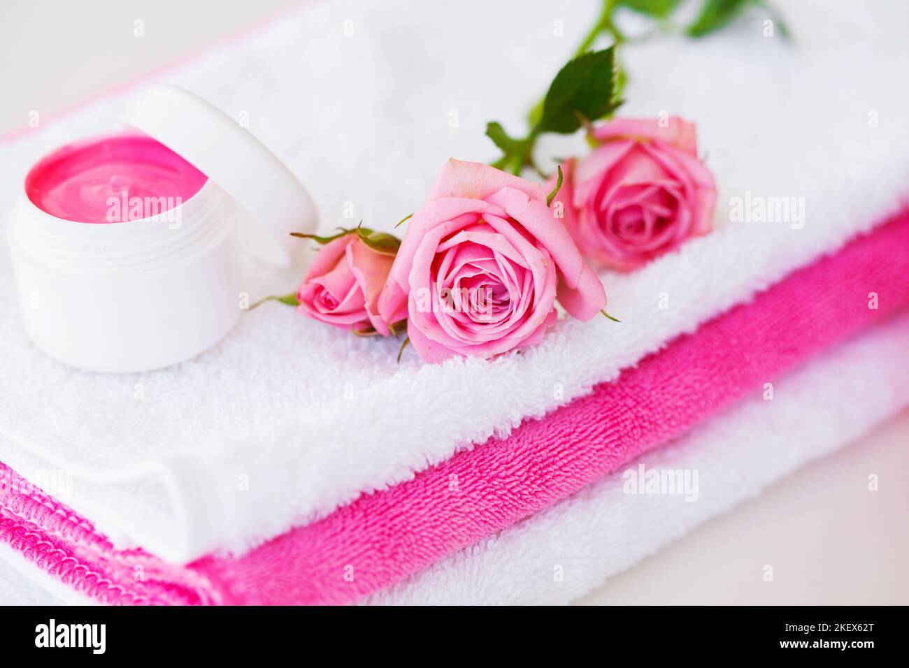 Spa. Wellness Products and Cosmetics. Towels, cream and pink flowers ...