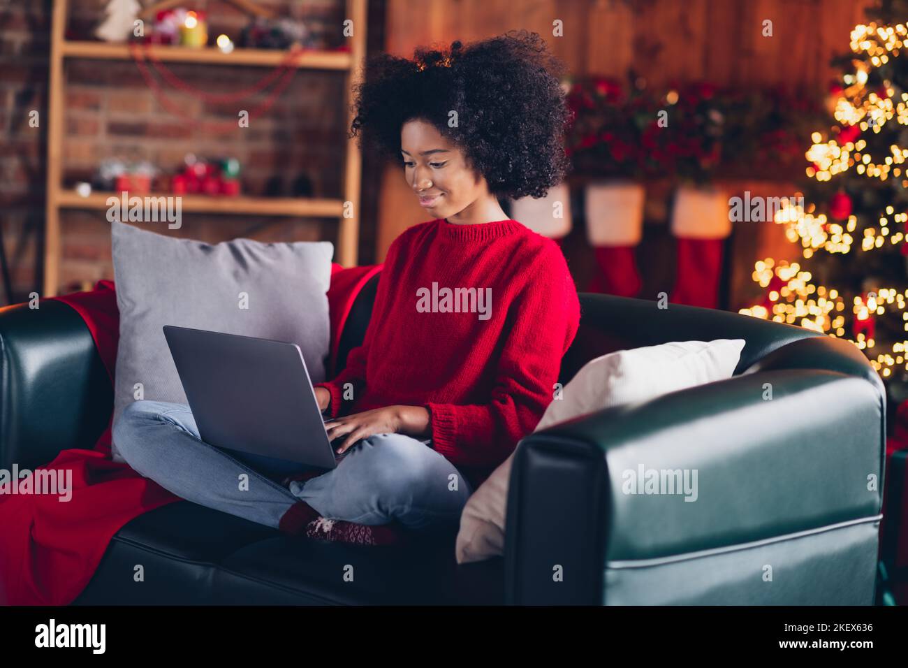 Full length photo of adorable small girl sit couch use wireless netbook ...