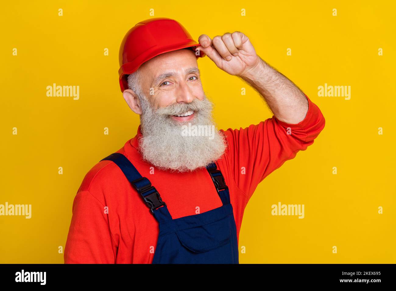 Photo of cheerful positive age man workwear overall arm red hard hat ...