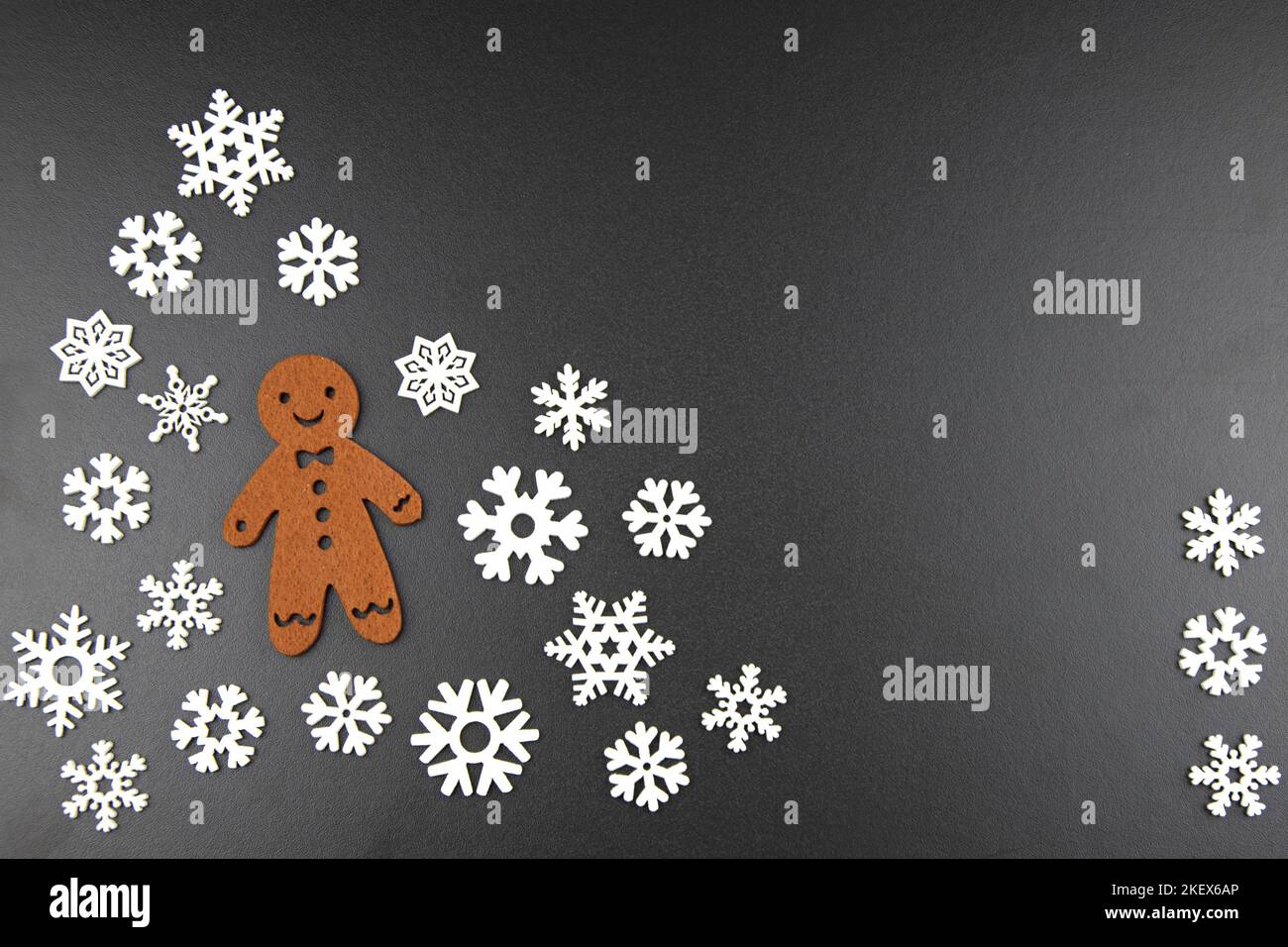 White christmas snowflakes on black background with gingerbread man ...