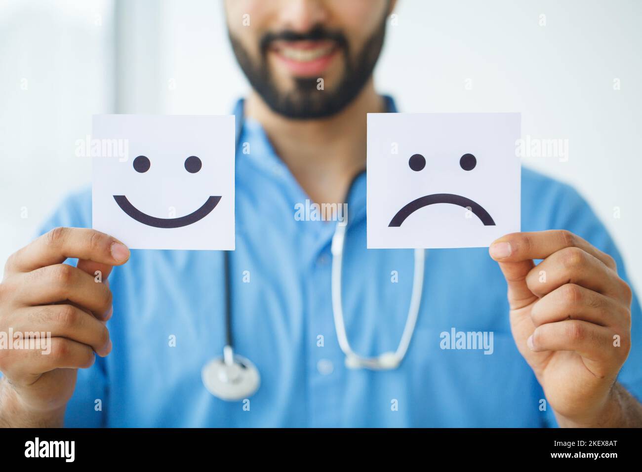 Health Care. Doctor Holding a Cards With Symbol Fun and Sad Smile ...