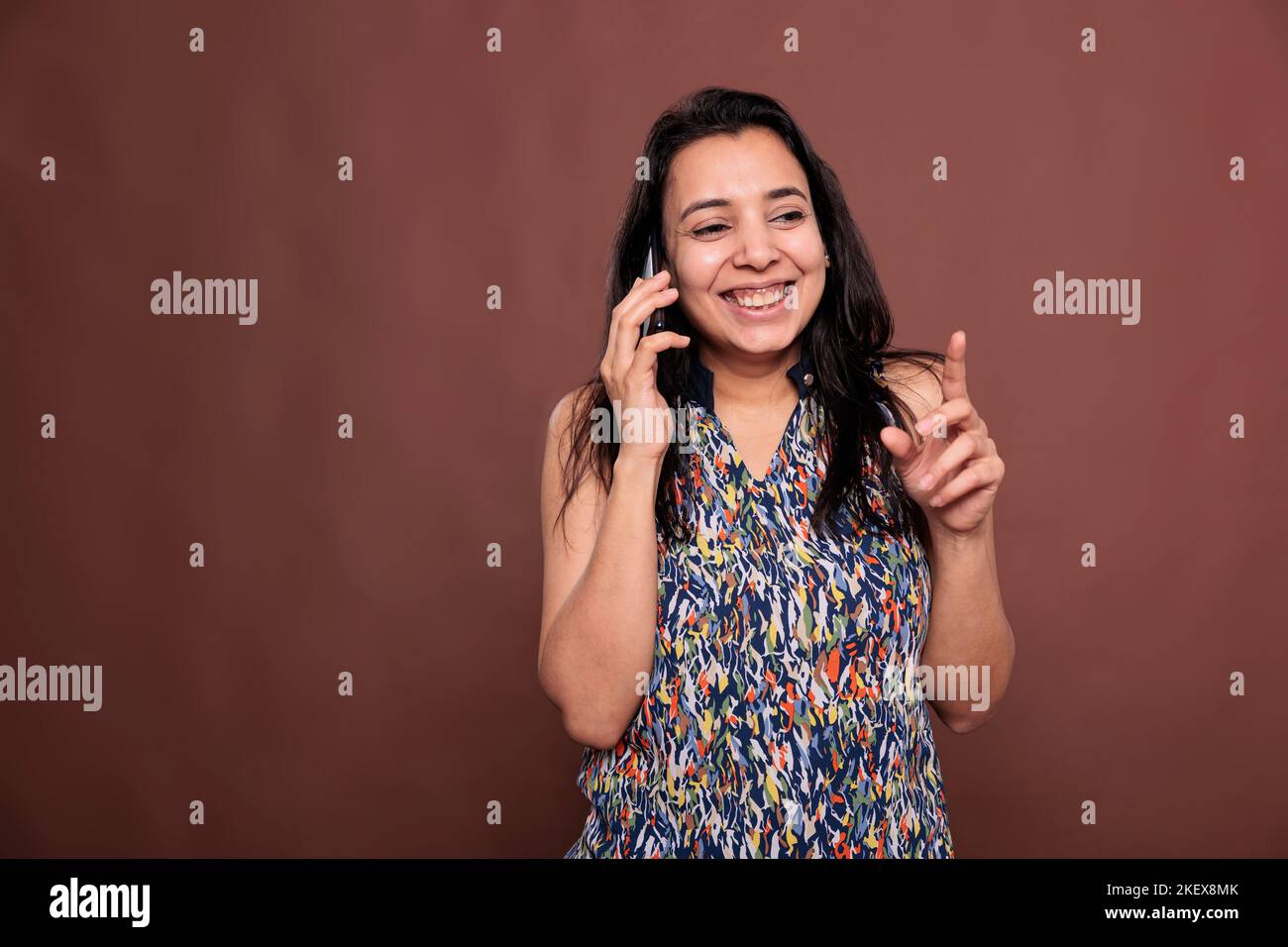 Smiling happy indian woman talking on smartphone, laughing, having ...