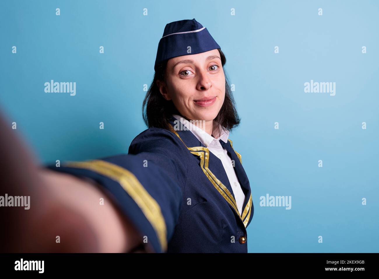 Smiling flight attendant taking selfie first person view, airplane ...