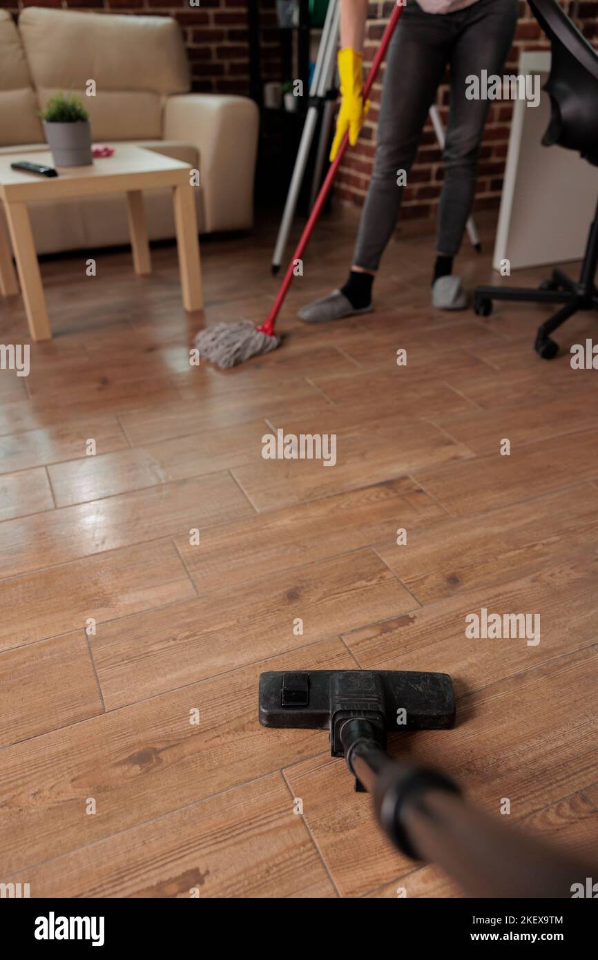 Unrecognizable people concentrating on cleaning house, using vacuum ...