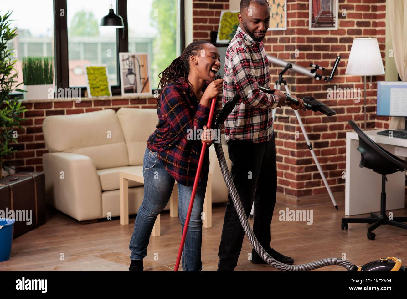 Afro American Couple Turning Spring Cleaning Into A Party Of Dancing